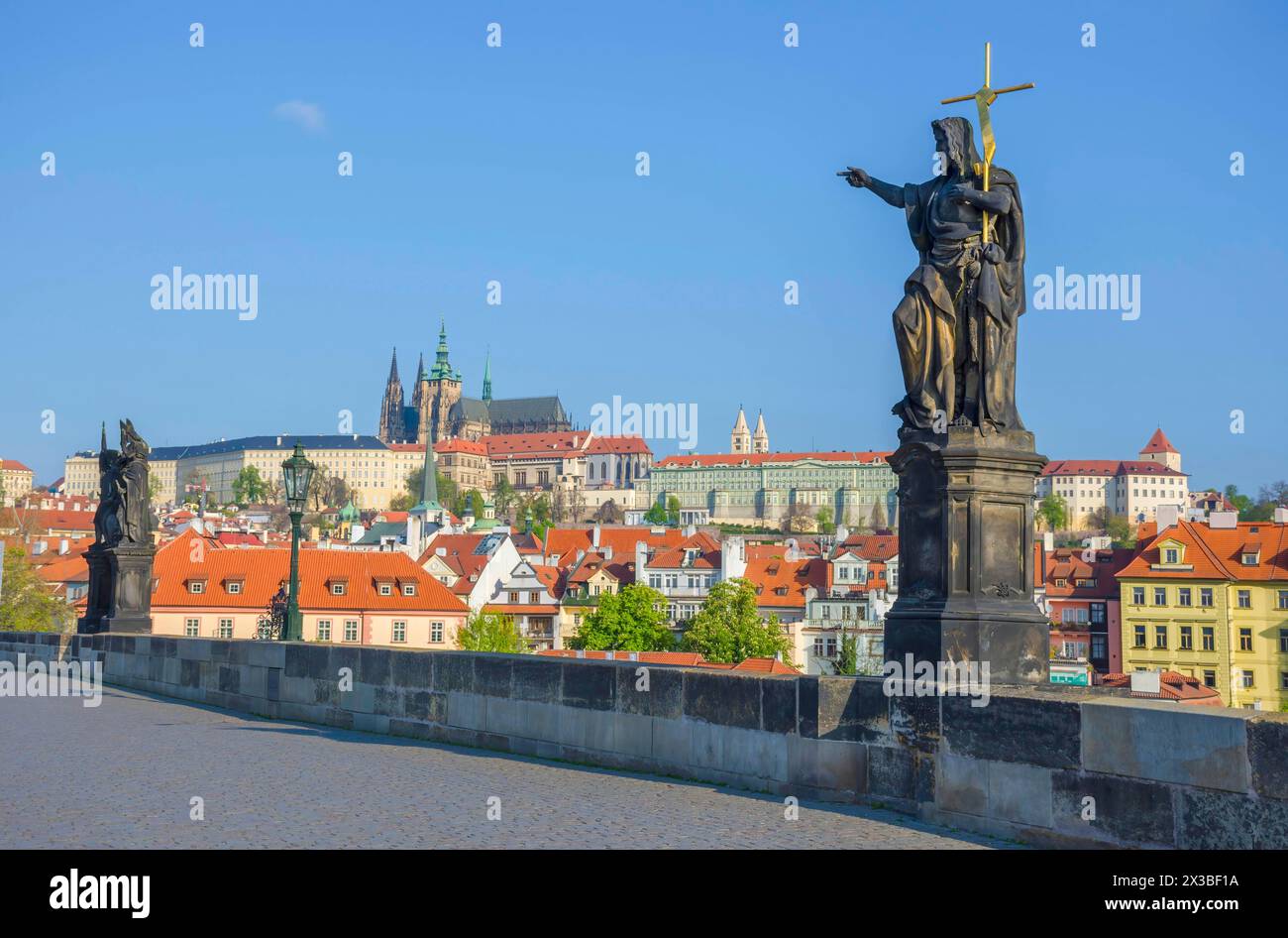 Statue of St. John the Baptist on Charles Bridge, with Hradcany castle ...