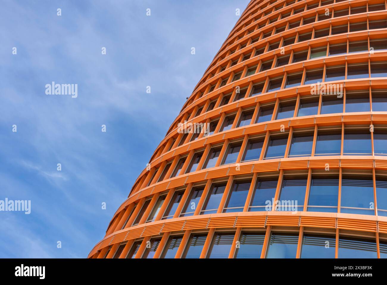 Detail of a skyscraper's curved facade with repeating window patterns ...