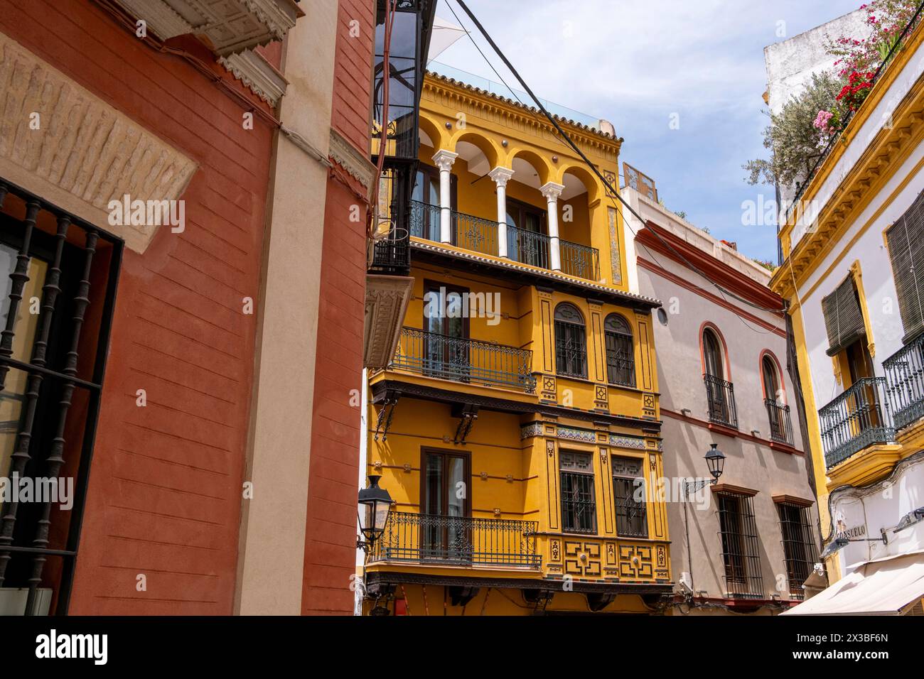 Historic building with yellow facade and decorative trim on balconies ...