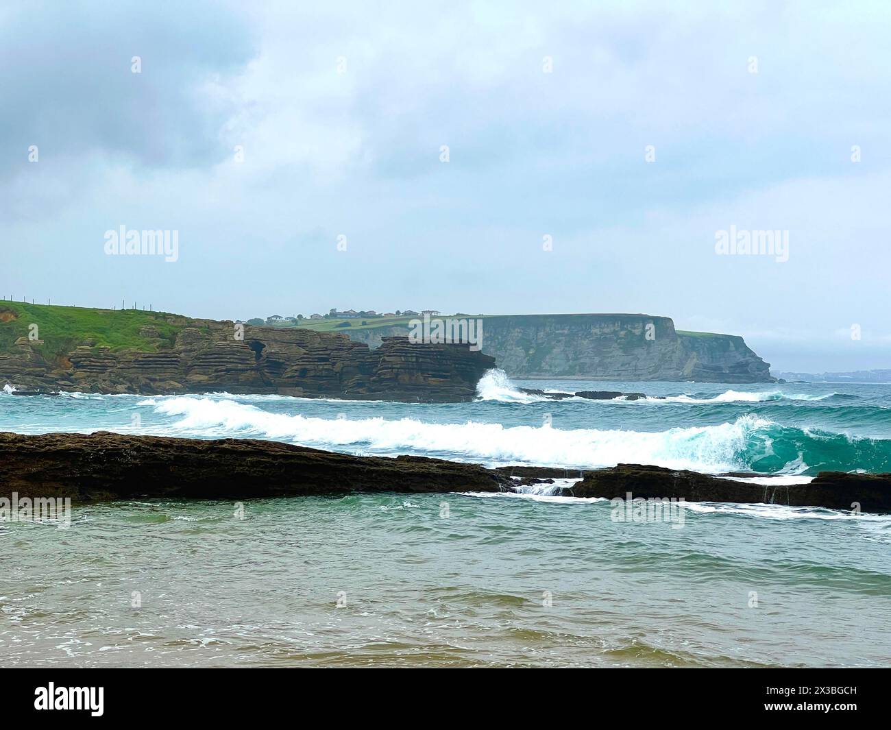 Ocean waves breaking and arriving at the shore of the beach Stock Photo ...