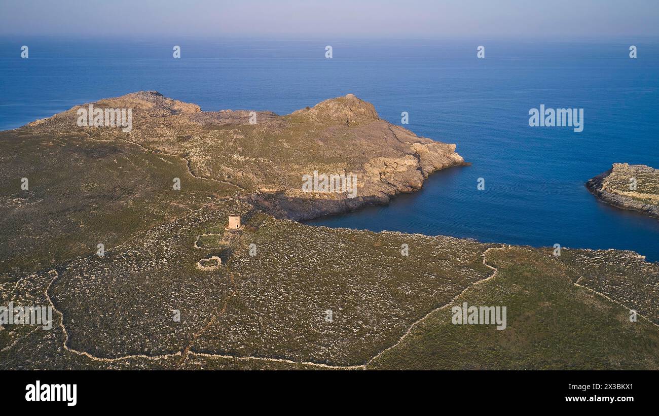 Drone shot, Lindos, Late afternoon light, Calm peninsula jutting out ...