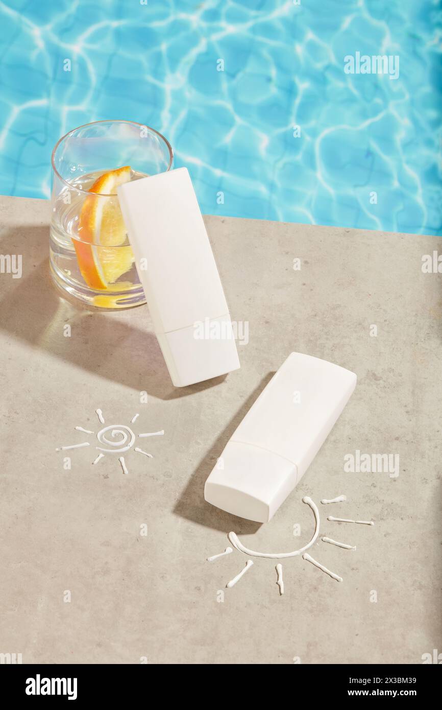 On the concrete surface, sun drawn from sunscreen, two white tubes and ...