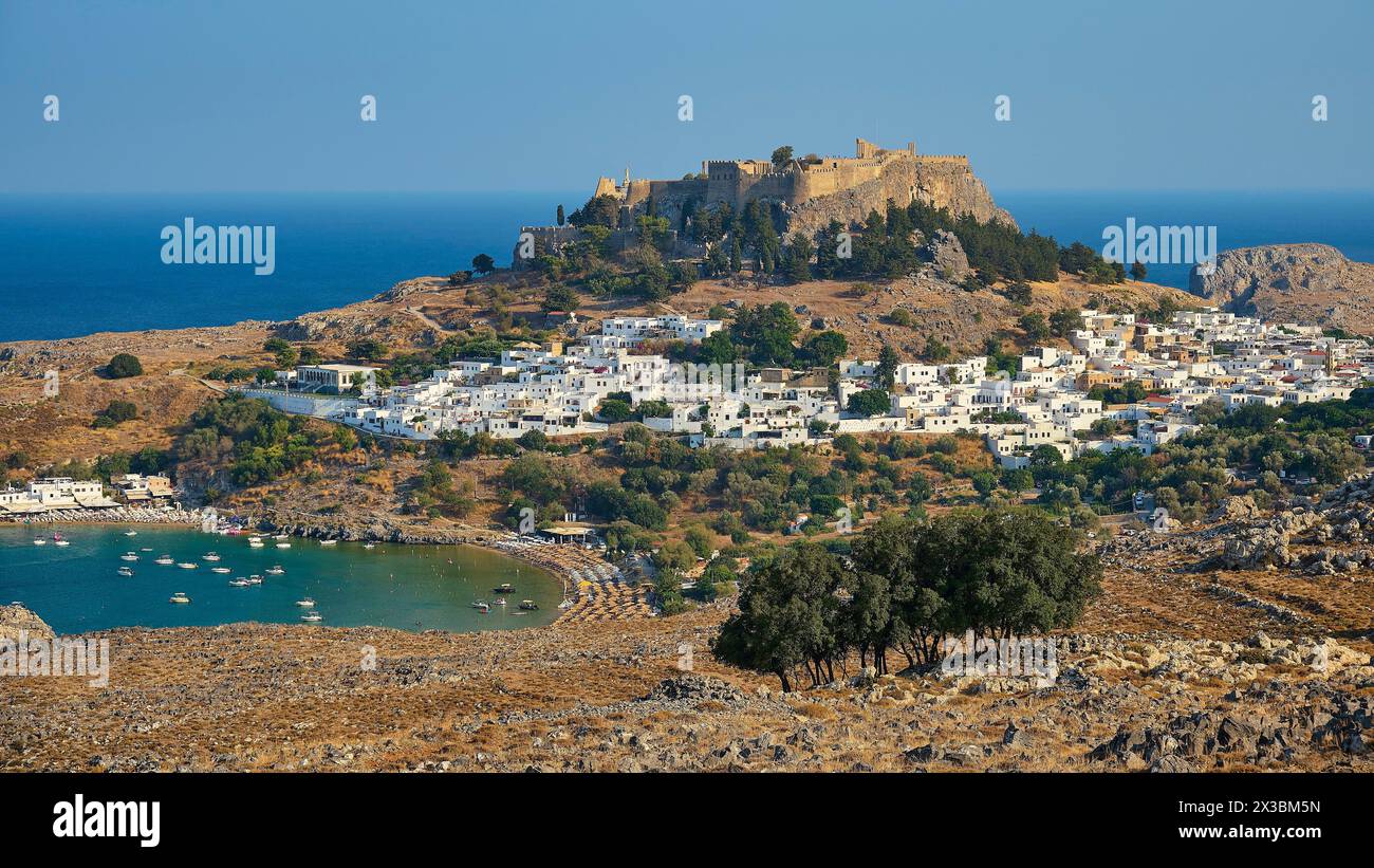 View of a picturesque coastal village with emerald green sea and a ...