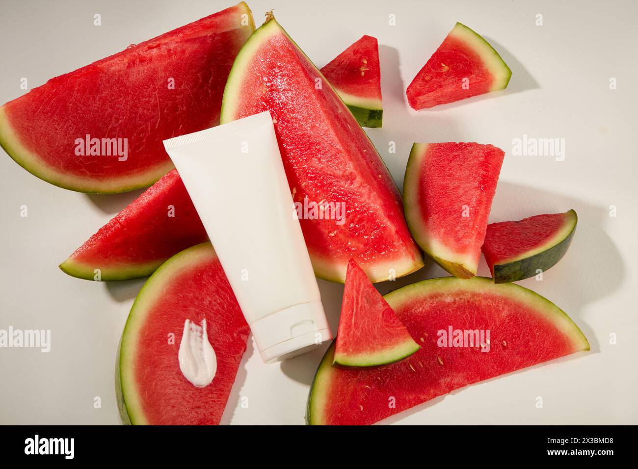 View from above of a cosmetic tube lying on some large watermelon ...