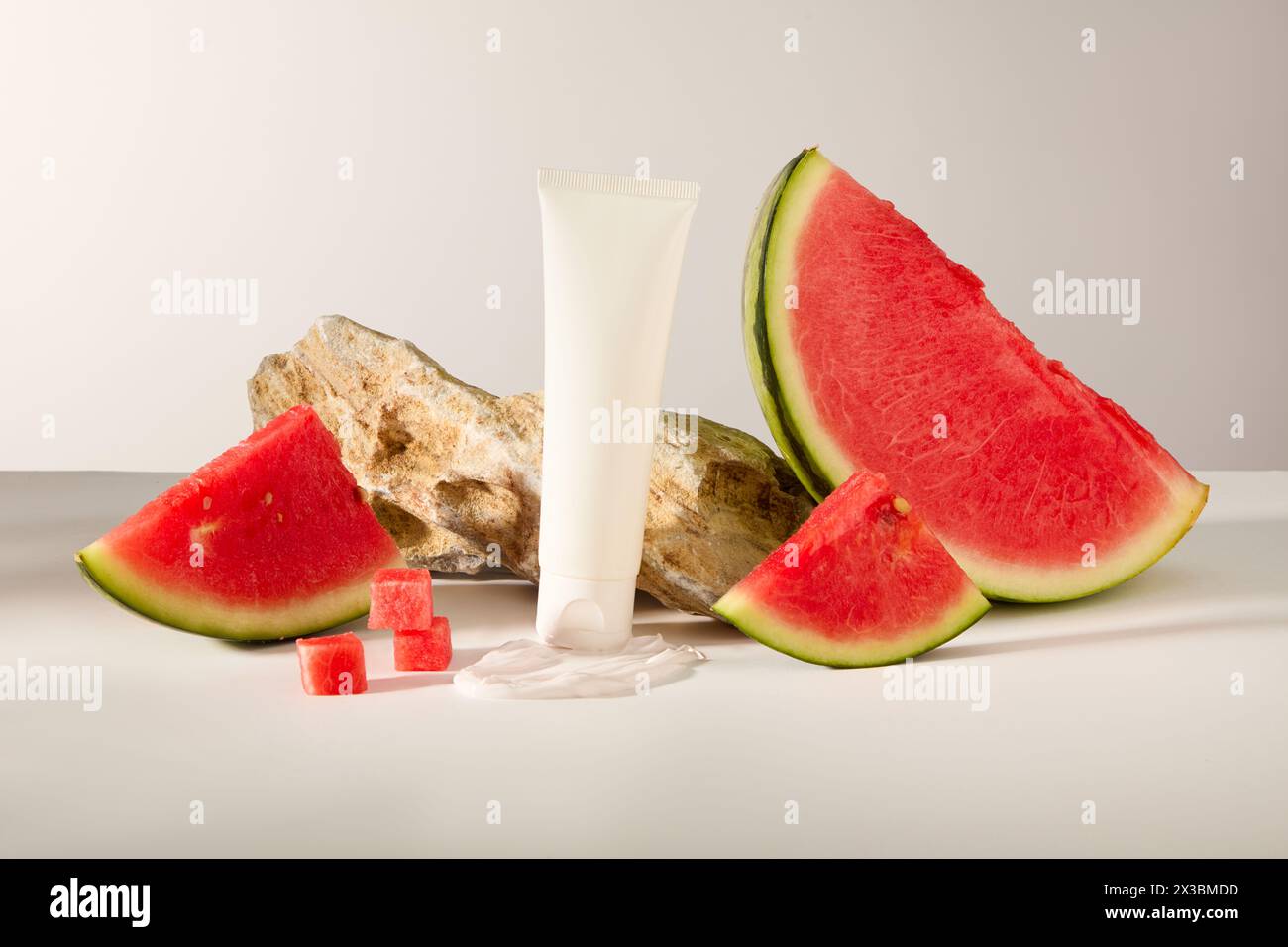 Unlabeled white tube decorated with watermelon and a white cream smear ...