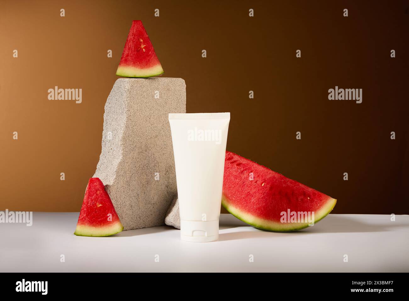 Front view of an empty label tube in white color with few stones and ...