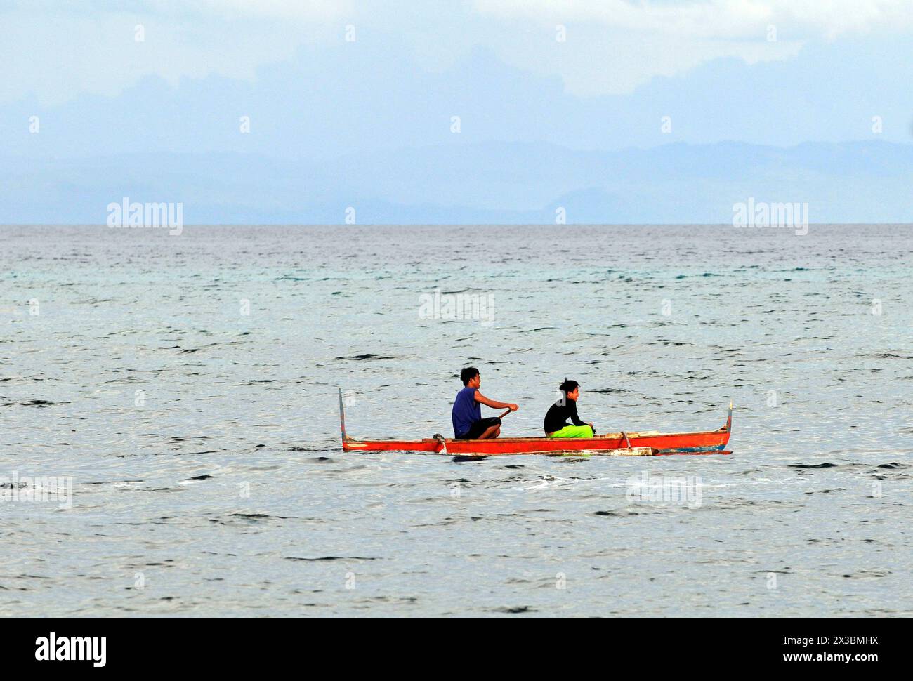 A Filipino fisherman in a bangka boat in Malapascua, Central Visayas ...