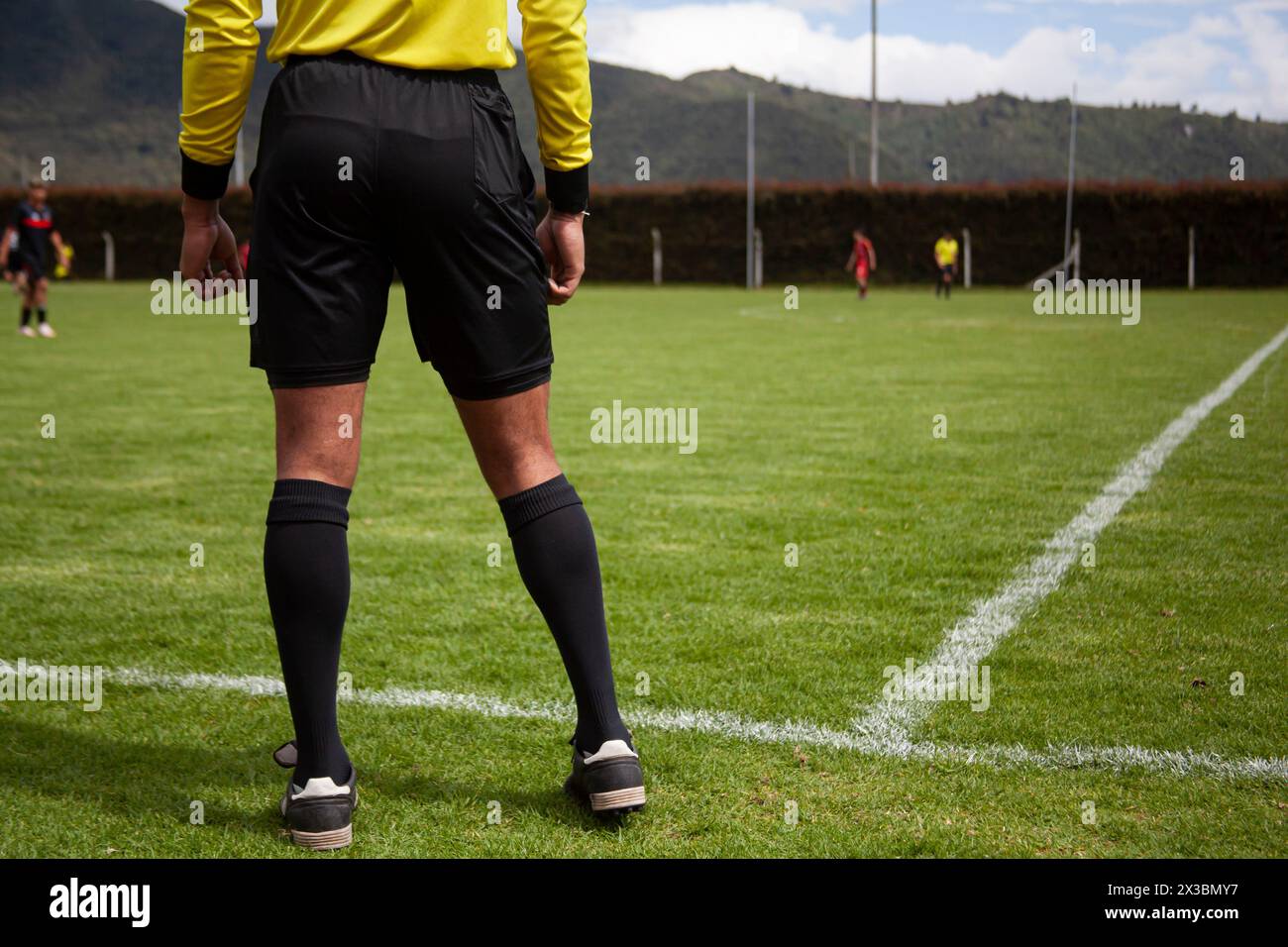 Half body Soccer referee with his back to the field observing the match ...