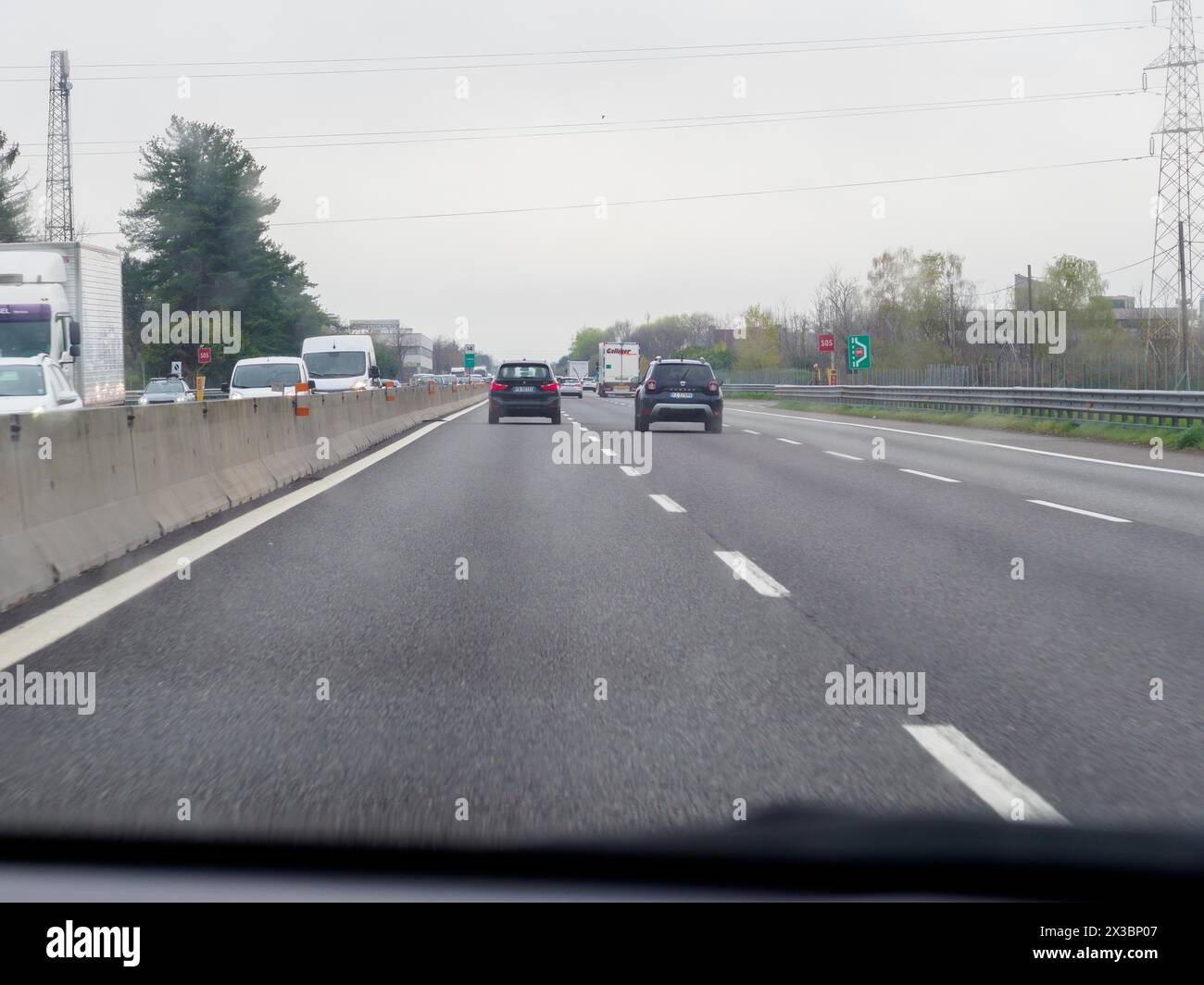 Driving on a highway with multiple lanes and overcast skies above, A1 ...