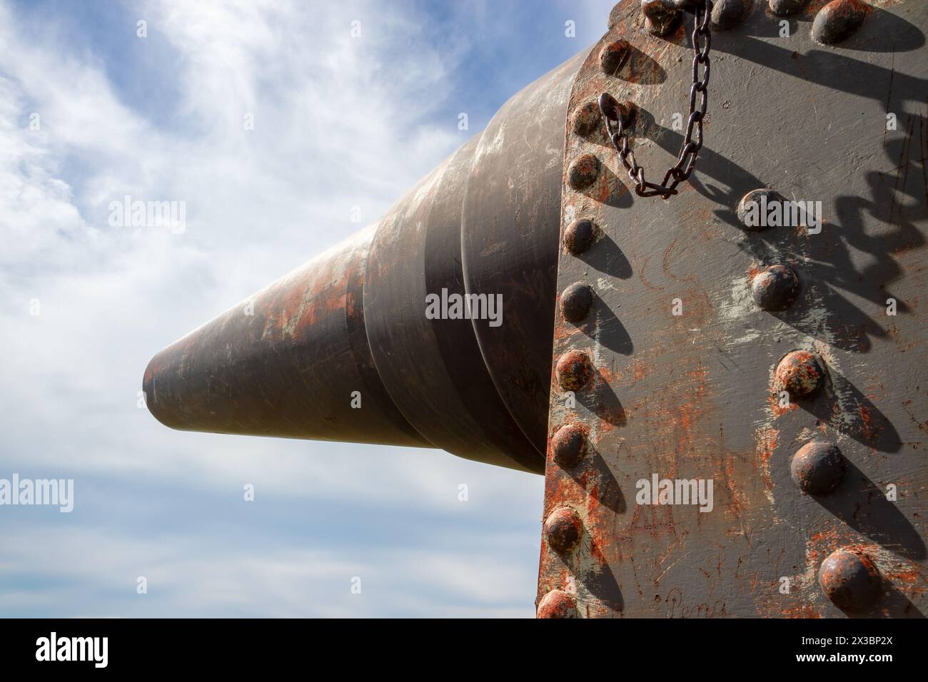 Giant iron cannon against a blue sky with clouds Stock Photo - Alamy