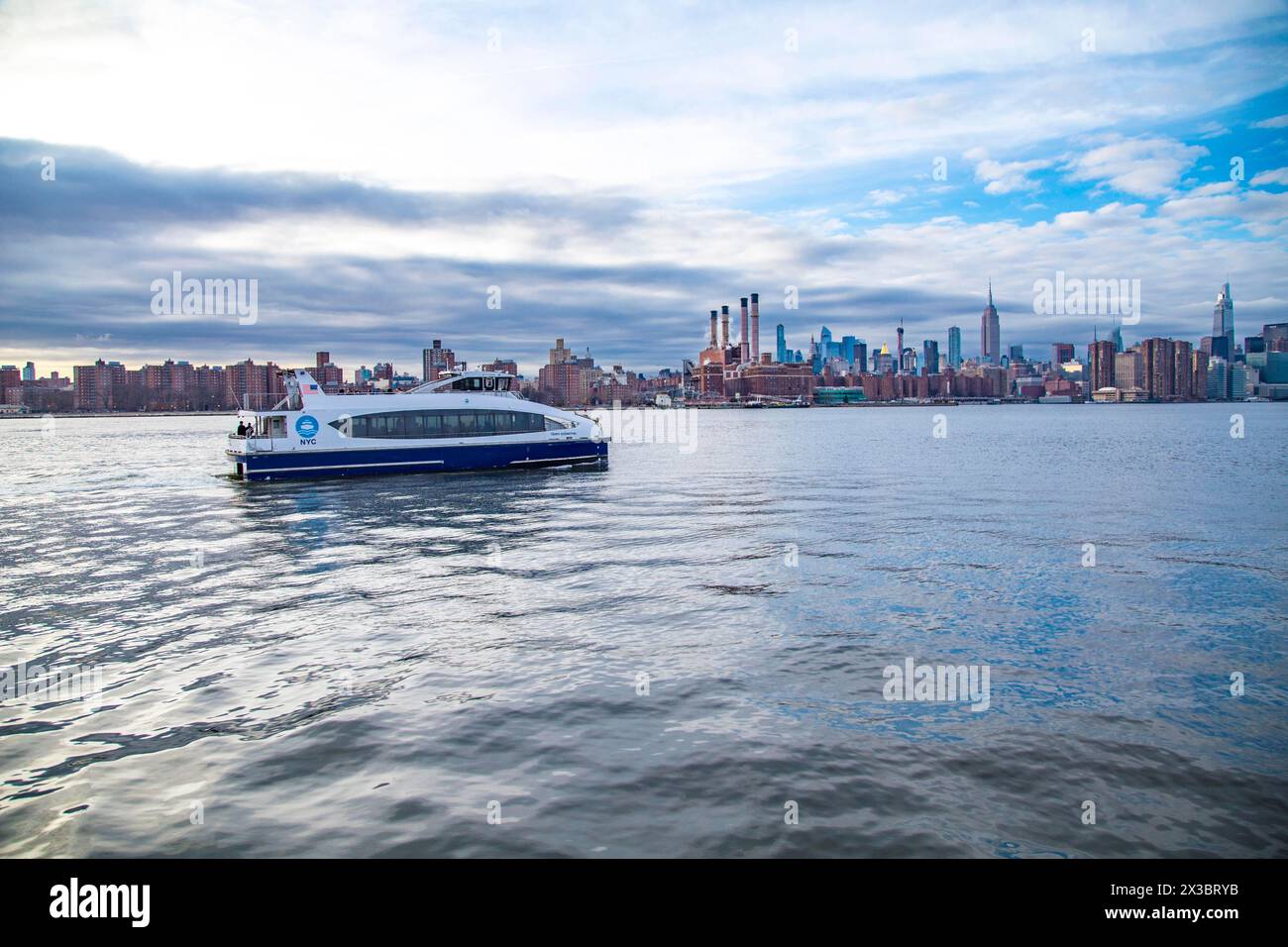 Ferryboat of the New York City Ferry Service on the East River against ...
