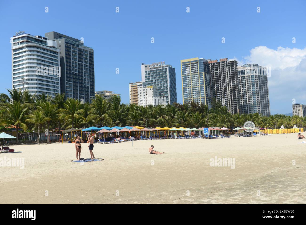 The beautiful long white sand beach along the changing waterfront ...