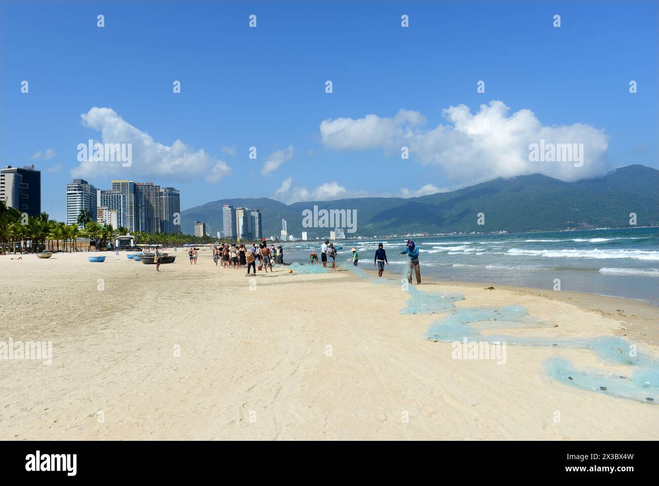 The beautiful long white sand beach along the changing waterfront ...