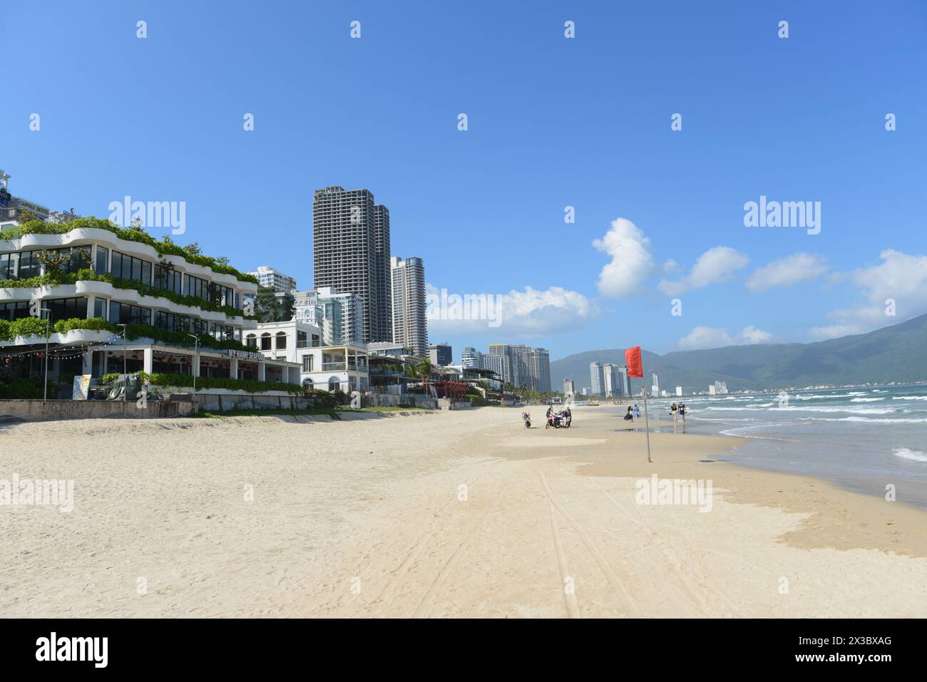 The beautiful long white sand beach along the changing waterfront ...