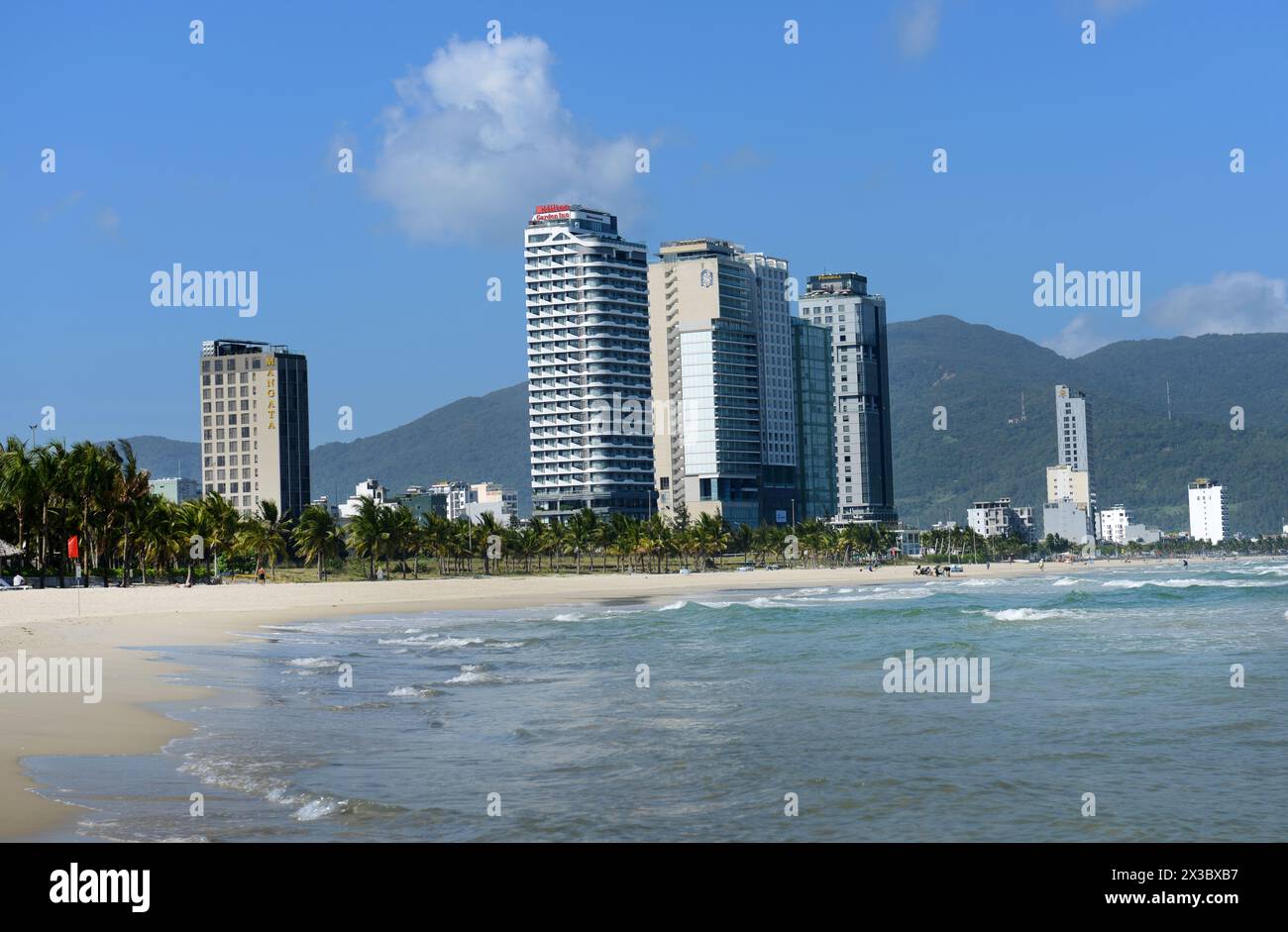 The beautiful long white sand beach along the changing waterfront ...