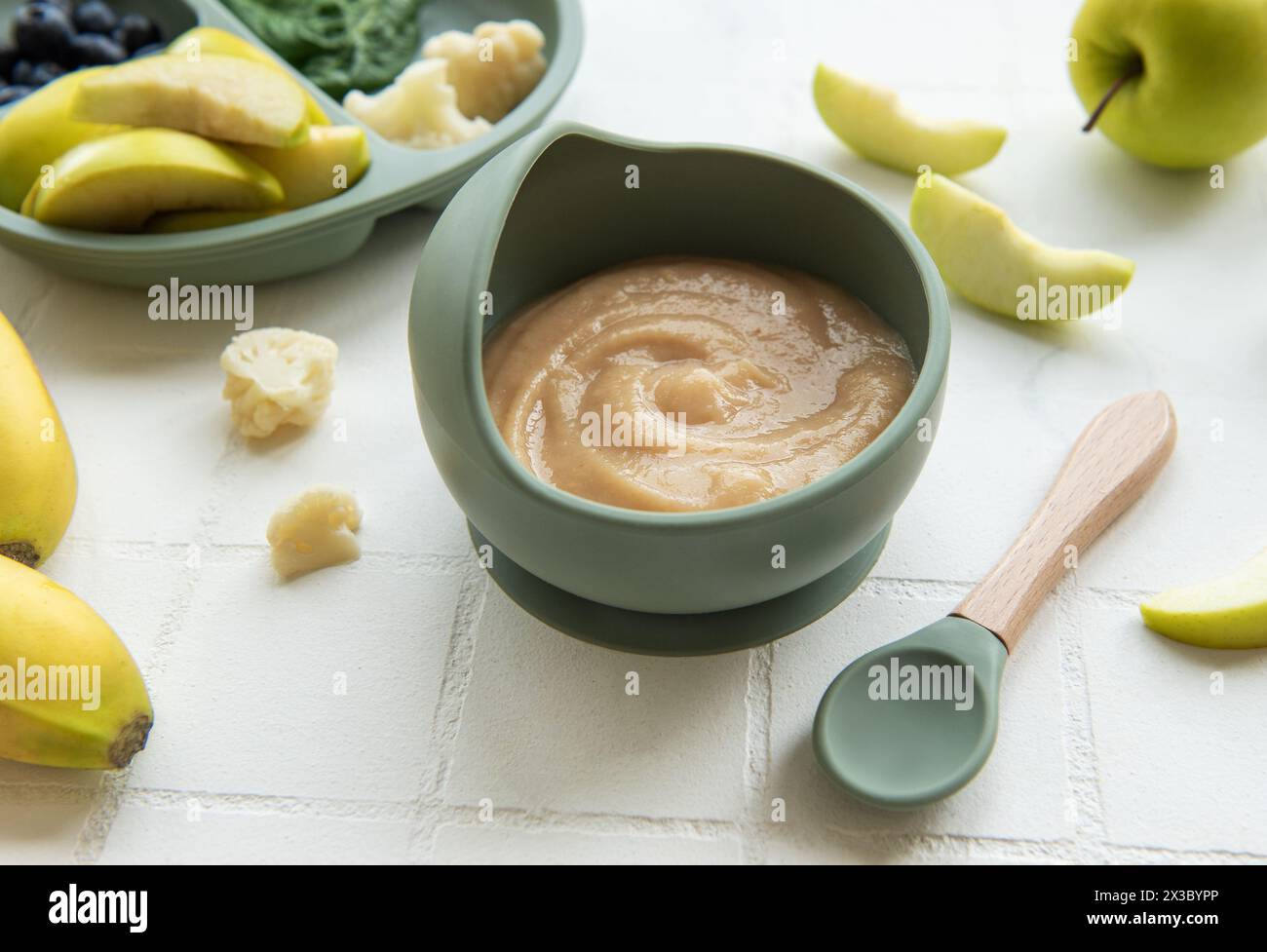 Healthy baby food in bowl. Fruity baby food with apple and banana on ...