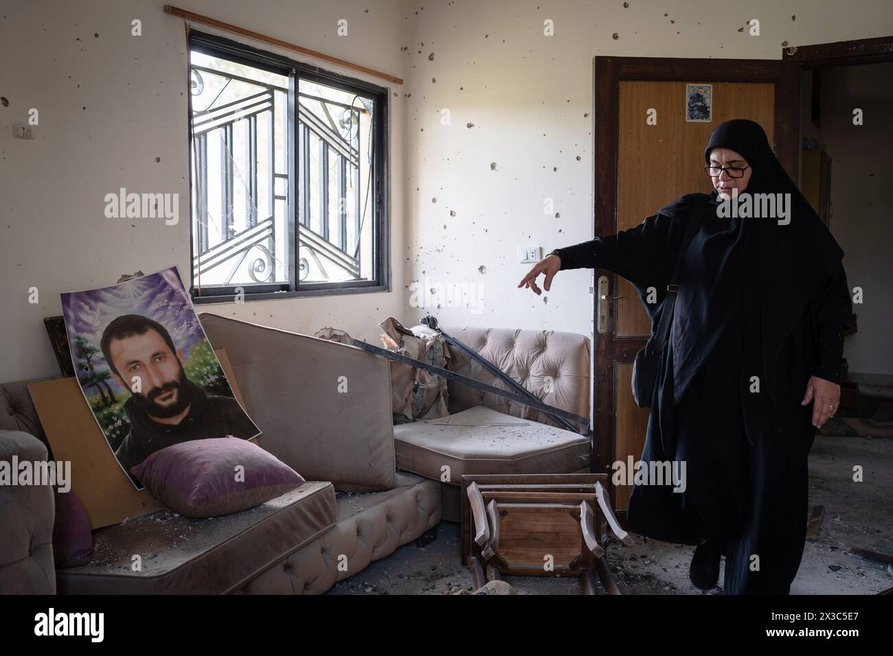 Hanin, Lebanon. 25th Apr, 2024. A woman seen showing the destruction of ...