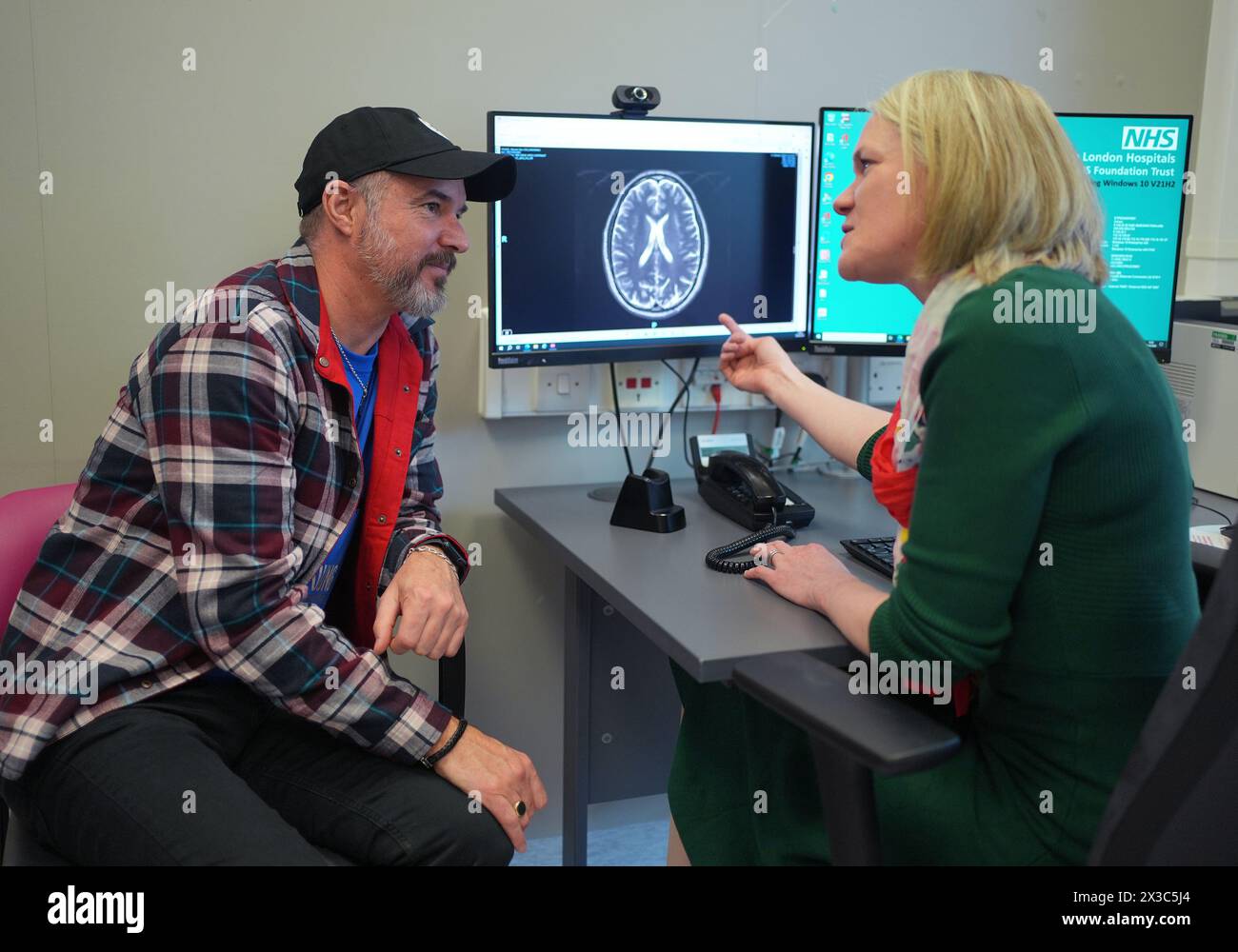 Consultant Dr Heather Shaw speaking to patient Steve Young, with an MRI ...