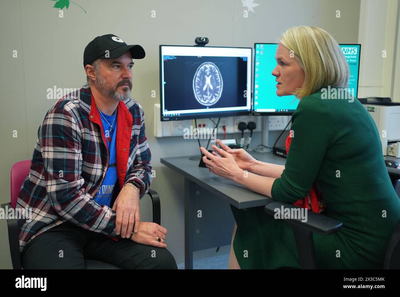 Consultant Dr Heather Shaw speaking to patient Steve Young, with an MRI ...