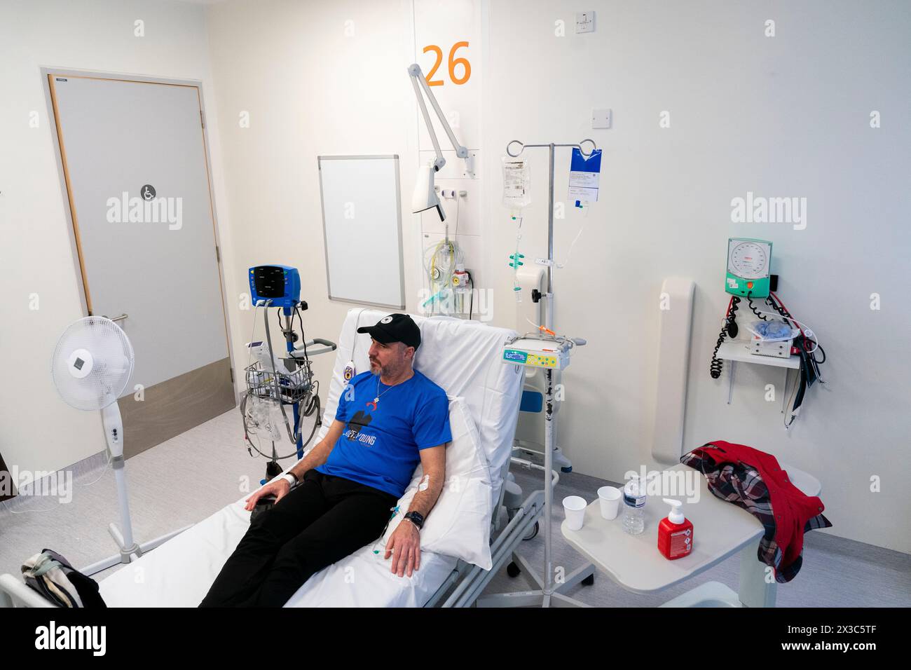 Patient Steve Young waits as infusion is administered, having received ...