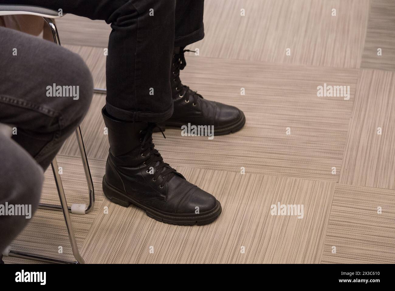 Women's feet in casual walking shoes. The surface is made of ceramic ...