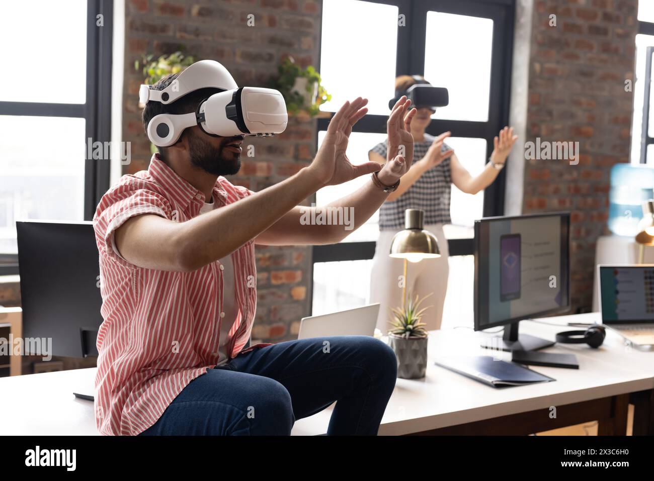 A diverse team, including an Asian male, explores virtual reality in a ...