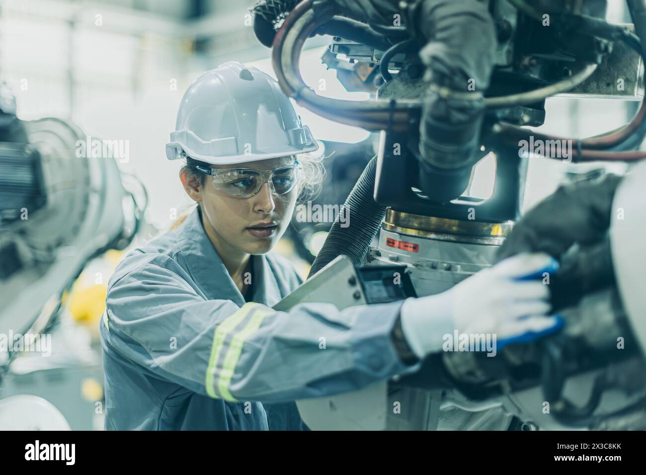 Engineer working machine assembly in advance technology robotic factory ...