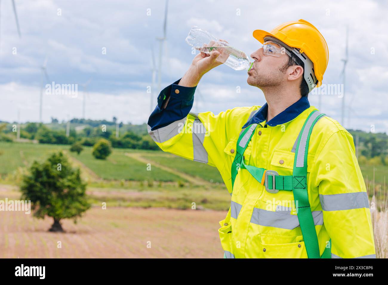 engineer worker man drinking water summer hot day. Tired worker finished work. Thirsty. Working ...