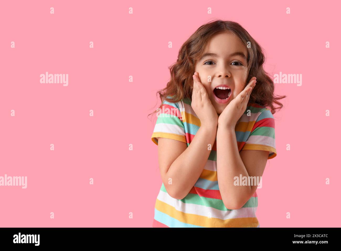 Shocked little girl on pink background Stock Photo - Alamy