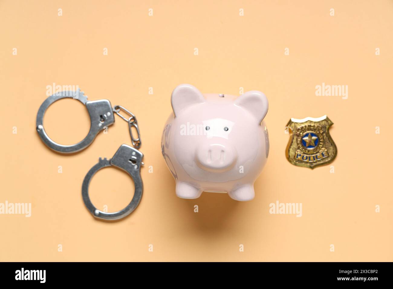 Piggy bank with handcuffs and police badge on orange background Stock ...