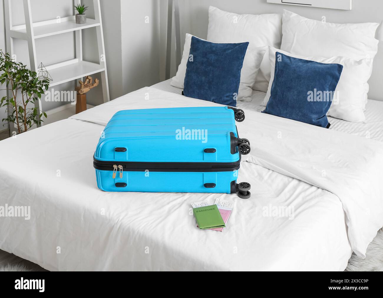 Suitcase and passports with tickets on bed in hotel room Stock Photo ...
