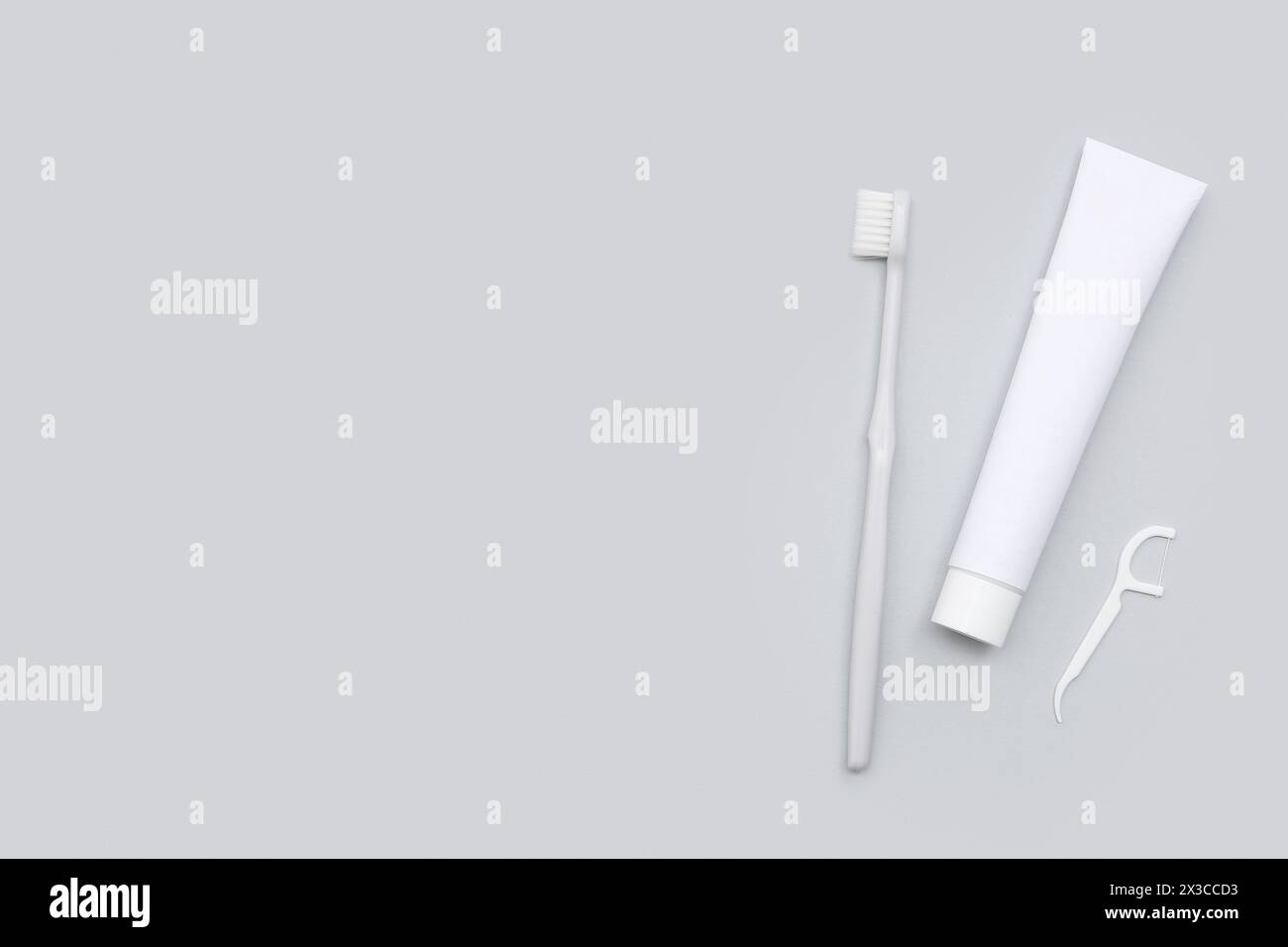 Toothpaste with toothbrush and floss toothpick on grey background Stock ...