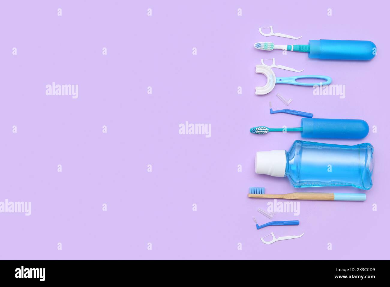Toothbrushes with floss toothpicks and mouthwash on lilac background ...