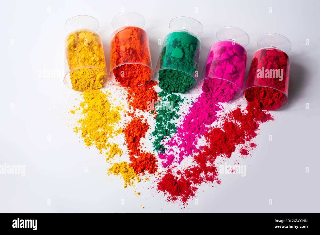 Colorful holi powder in a plastic containers on white background Stock ...
