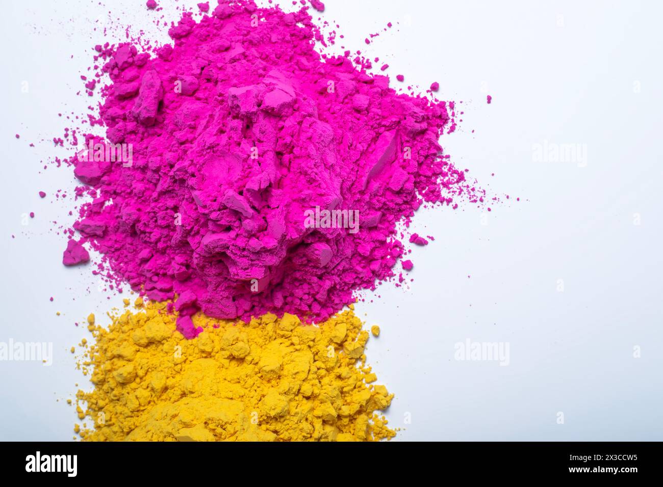 Pile of yellow and pink color holi powder isolated on white background ...