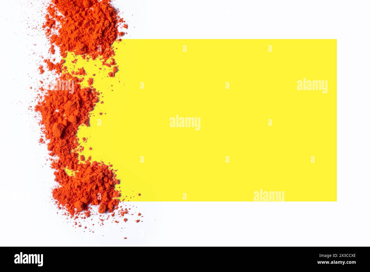 Yellow frame on white background with red holi powder on it. Happy Holi ...