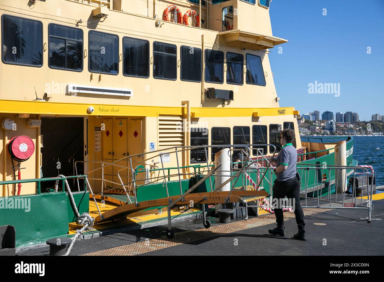Sydney ferry Golden Grove at Cremorne Point ferry wharf, ferry employee ...