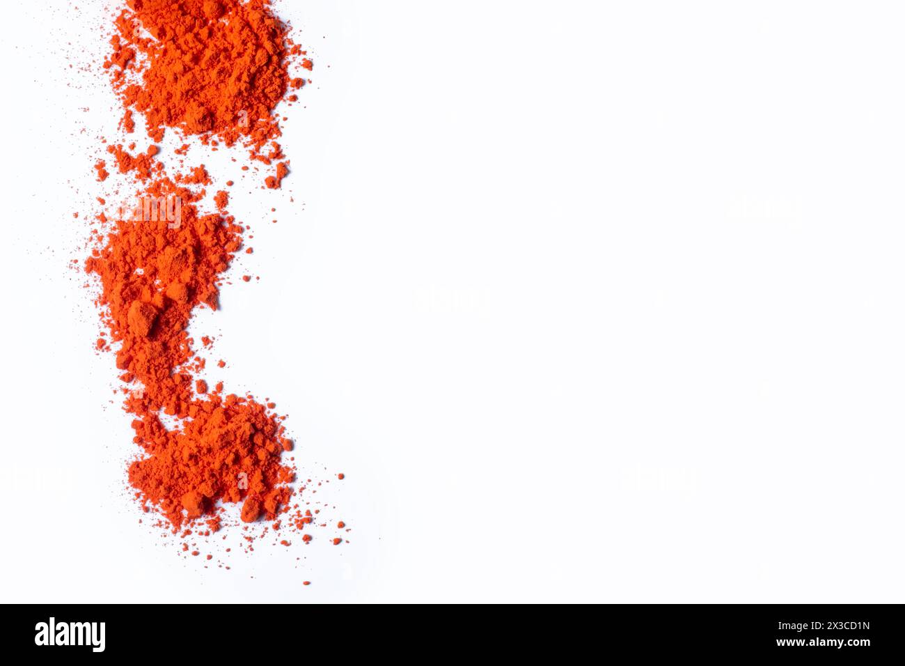 A pile of red and orange pigment powder isolated on white background ...