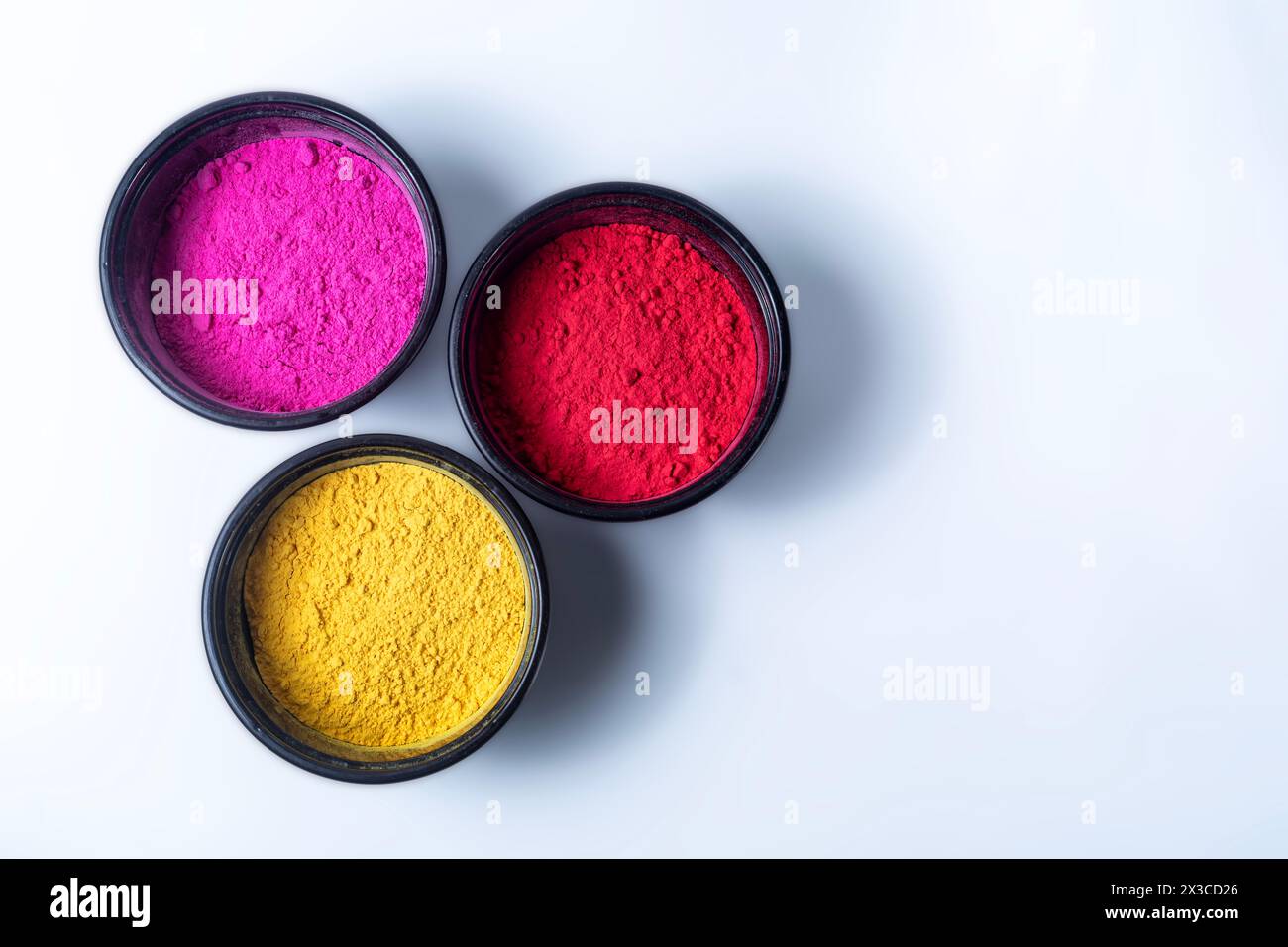 Colorful holi powder in a bowl isolated on white background. Holi is ...