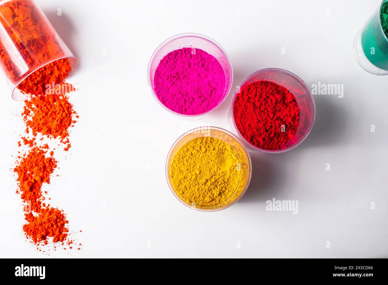 Colorful holi powder in glass jars on white background, top view Stock ...