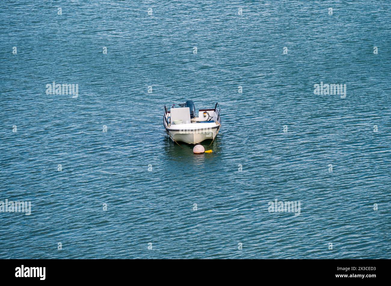 A boat anchored at shallow water Stock Photo - Alamy