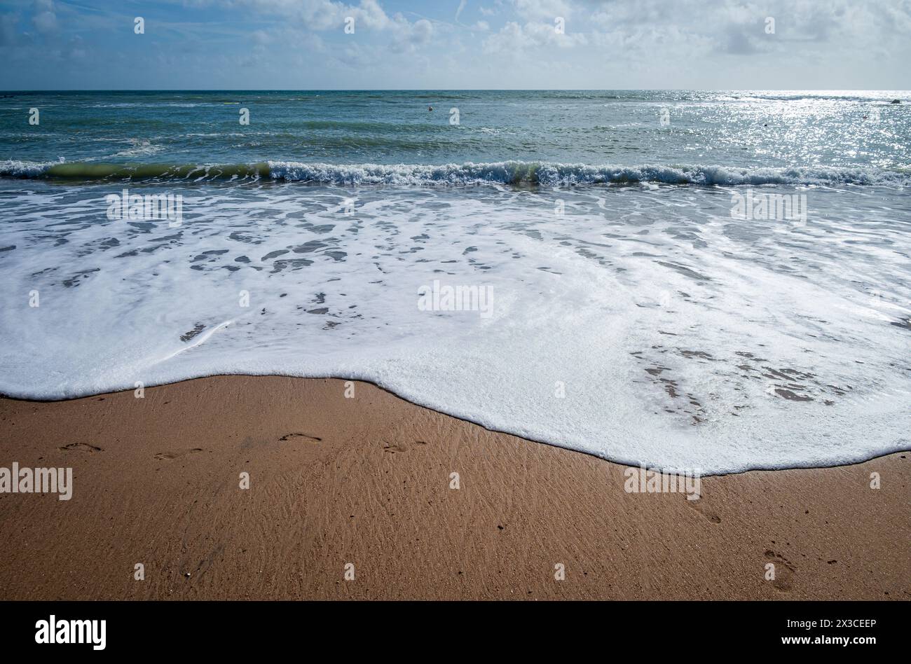 Curvy shape of gentle waves on sandy beach Stock Photo - Alamy