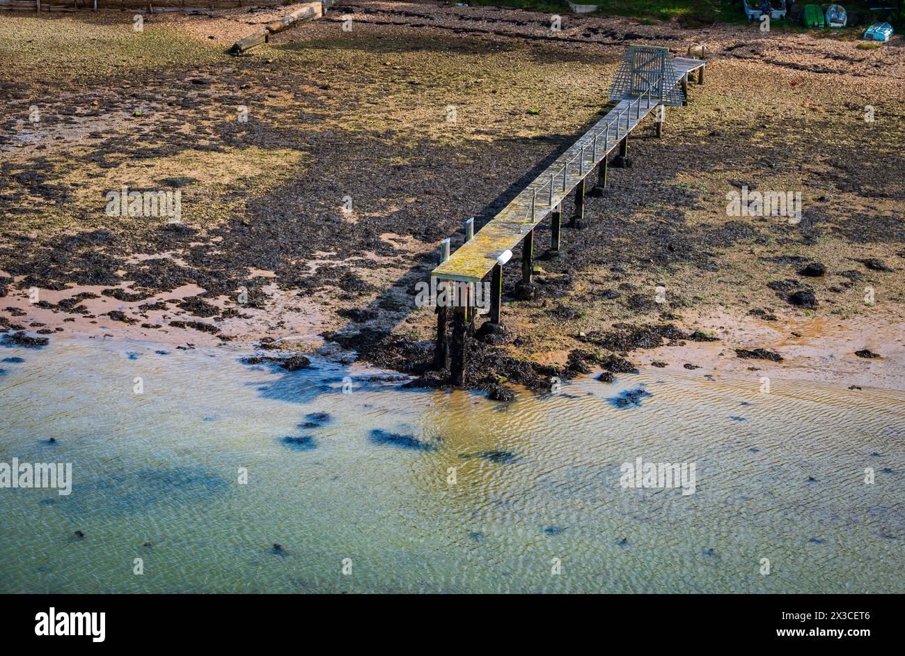 Small pier at low tide on the beach at Isle of Wight, UK Stock Photo ...