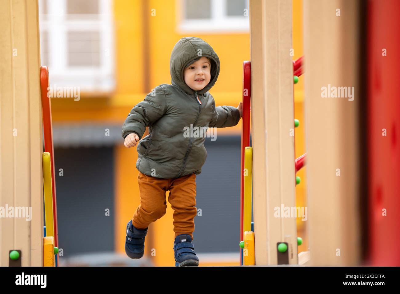 Cute happy toddler boy three years old is playing on the playground in ...
