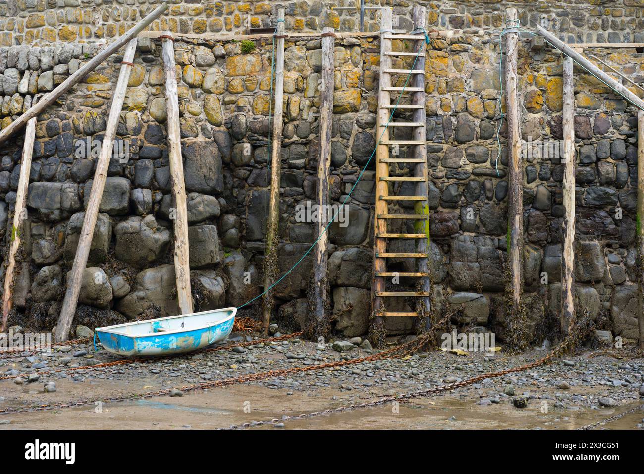 Small rowing boat moored at the quayside of Clovelly Harbour in Devon ...