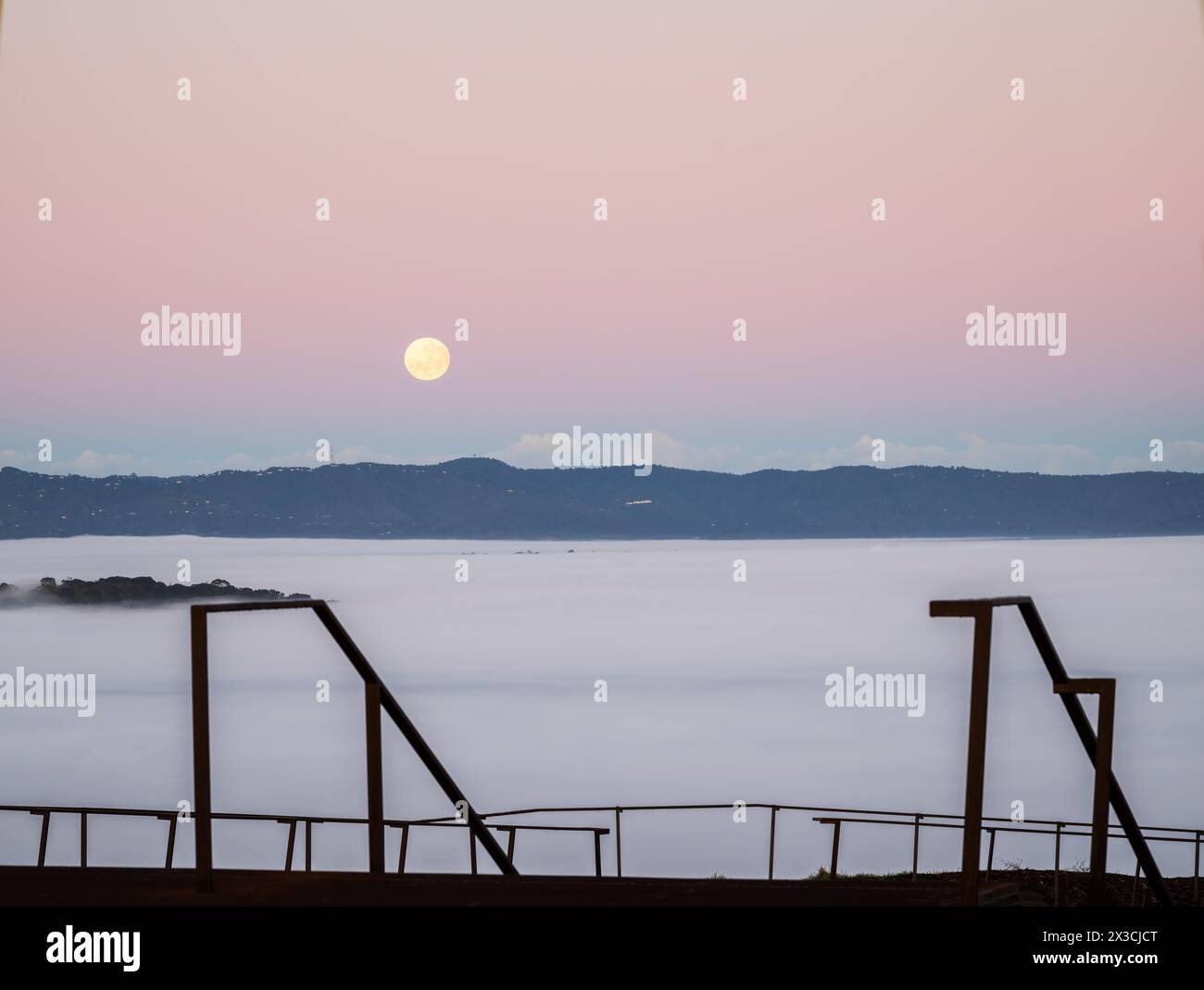 Full moon set in the west sky above the sea of fog. Viewed from Mount ...