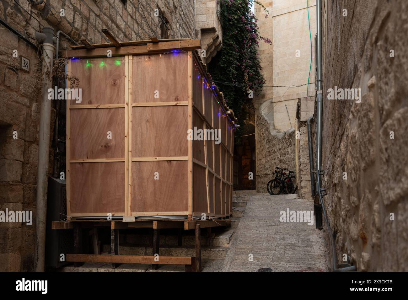 A street scene in Jerusalem during Sukkot, in which temporary, wooden ...