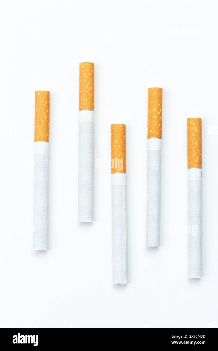 Five cigarettes on a white background from above Stock Photo - Alamy