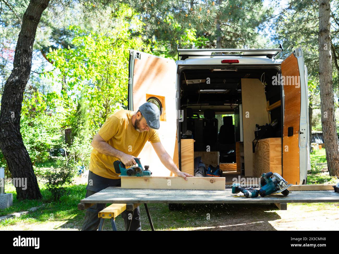 Man customizing his handcrafted camper van Stock Photo - Alamy