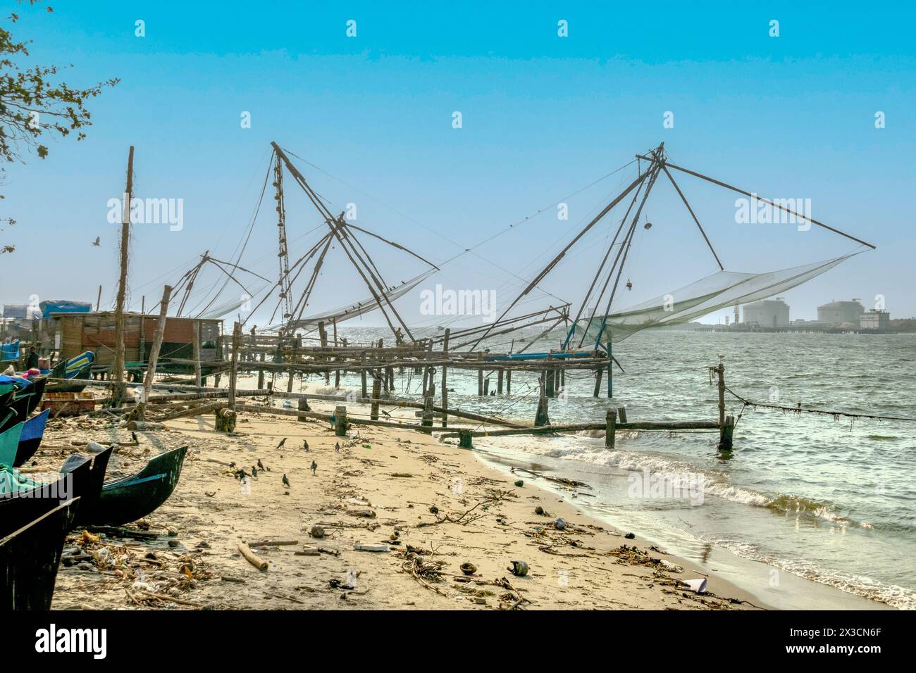 traditional fishing with fishing nets on a wooden scaffold at the sea ...